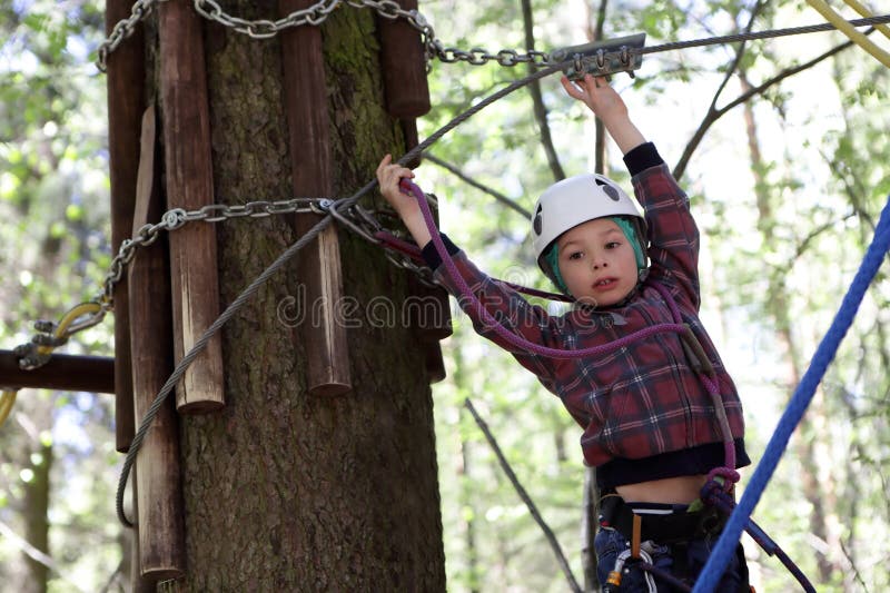 Boy climbing in rope park stock photo. Image of forest - 95858454