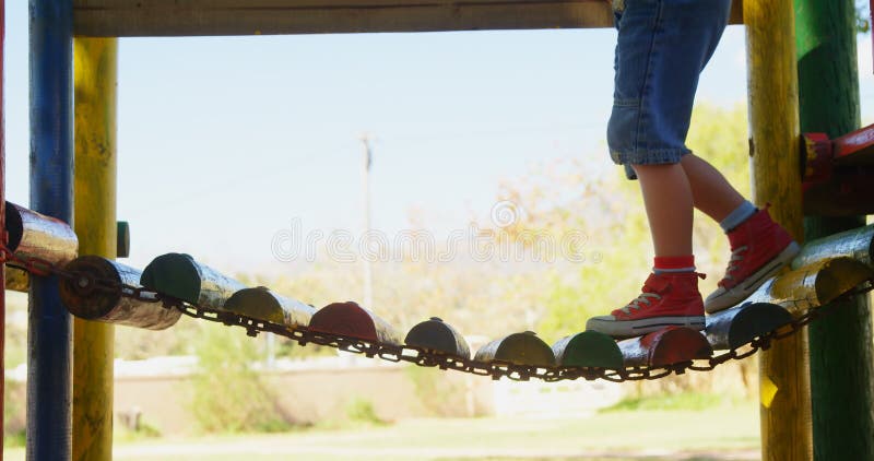 Boy Climbing an Small Wooden Hanging Bridge on the Playground 4k Stock ...