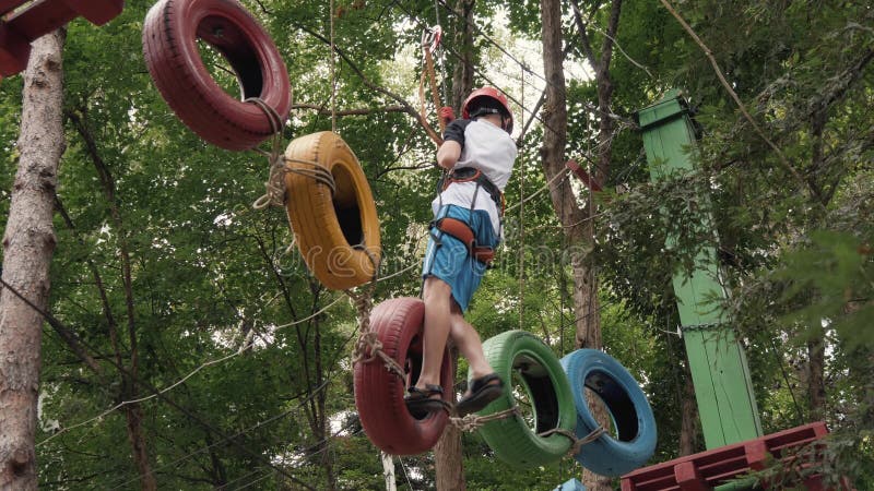 The Boy Climbs the Obstacle Course in the Camp. a Brave Boy Fulfills ...