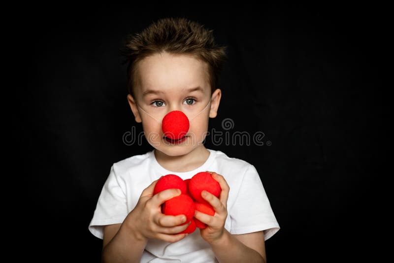 Boy with a Clown Red Nose and Red Noses in Hands. Red Nose Day. Stock ...