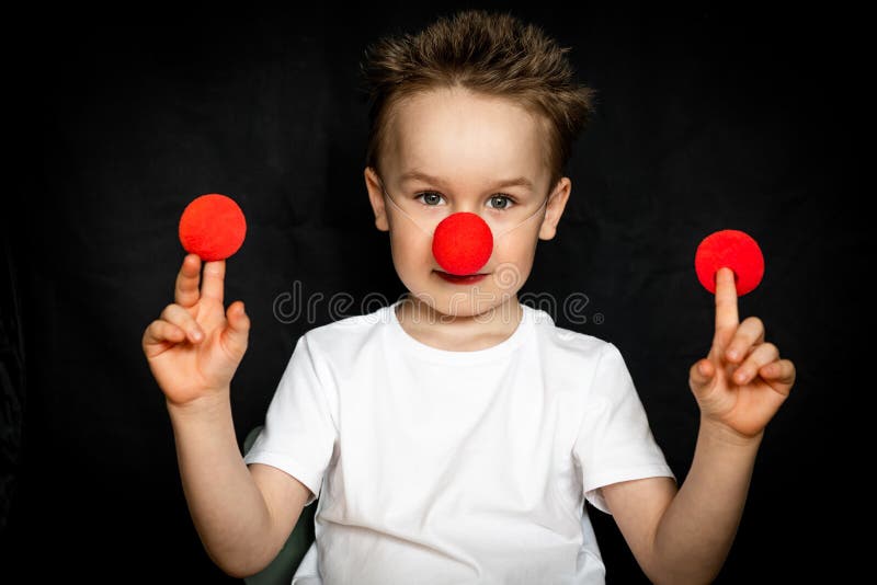 Boy with a Clown Red Nose and Red Noses in Hands. Red Nose Day. Stock ...