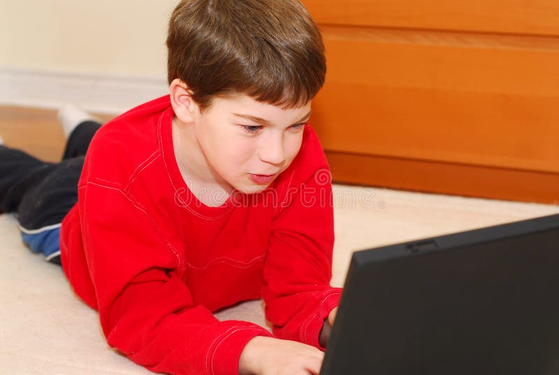 Boy using computer at home stock image. Image of computers - 34411323