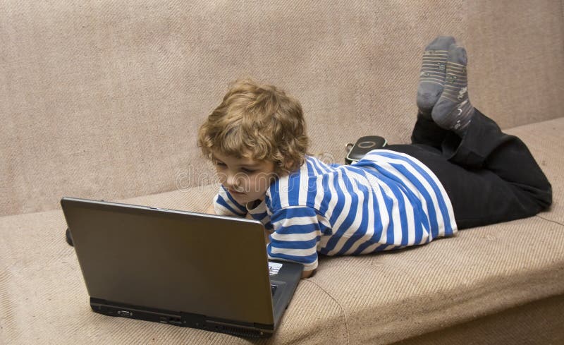 Boy with computer stock image. Image of laying, computer - 23781947