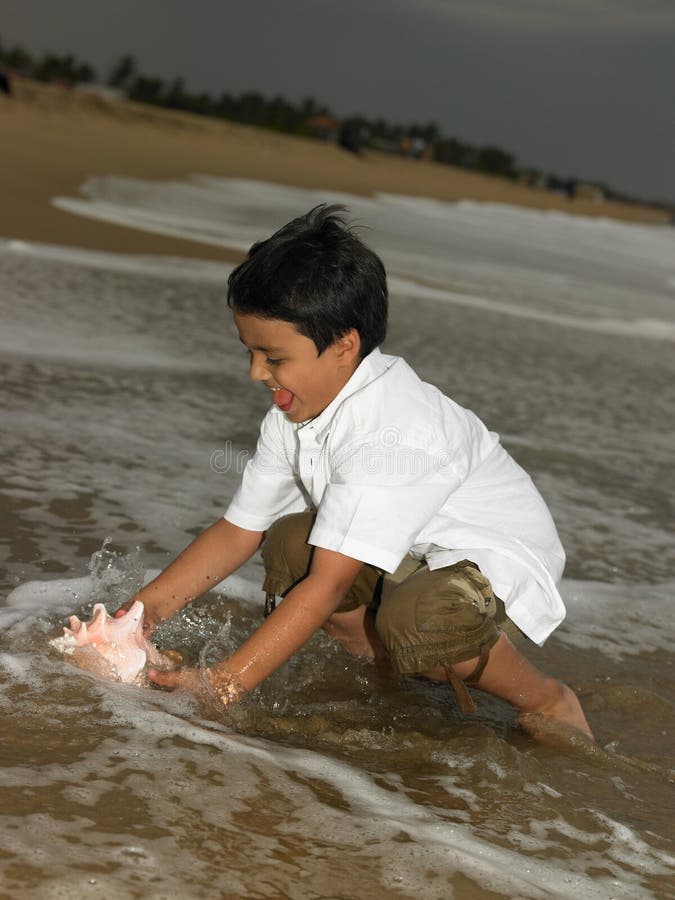 Boy with Conch at the Sea Shore Stock Image - Image of living, fair ...