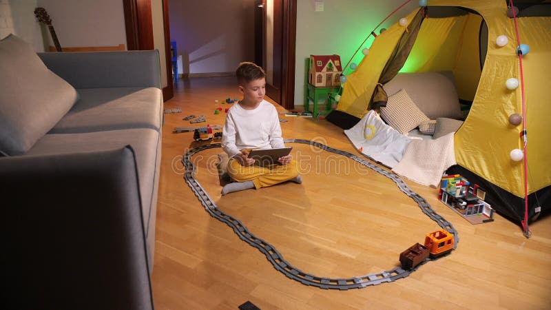 Boy Controls a Toy Train on the Railway Using a Tablet, Remote Control ...