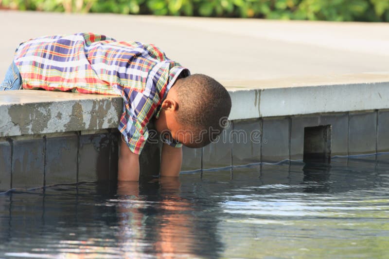 Boy Cooling of his Hands stock photo. Image of black, child - 5489442