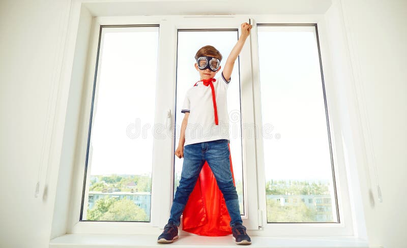 The Boy in the Costume of a Superhero at the Window Stock Photo - Image ...
