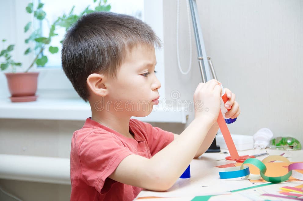 Boy Crafting with Paper Sitting on Table, Early Brain Developing Stock ...