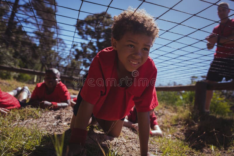 Boy Crawling Under the Net during Obstacle Course Training Stock Image ...