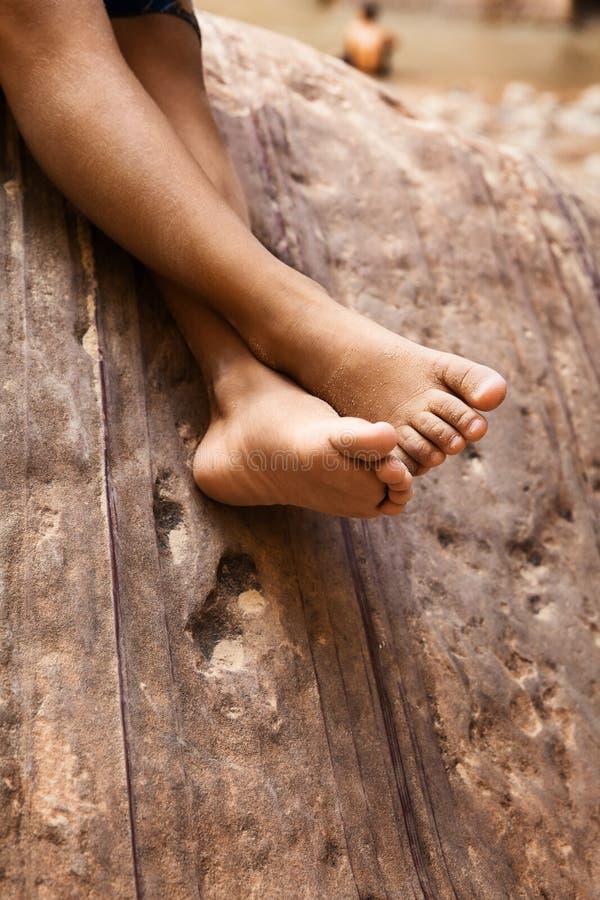 Boy Crossed His Legs while Sitting on Rock Stock Photo - Image of foot ...
