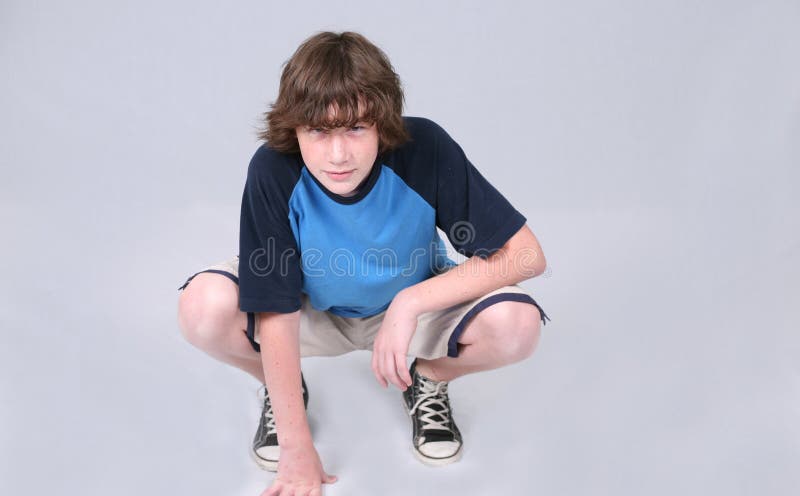 Boy crouching stock image. Image of caucasian, person - 16242799