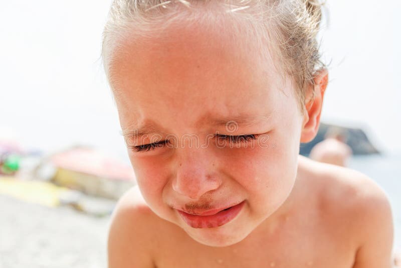 Boy crying on the beach stock photo. Image of nature - 83963386