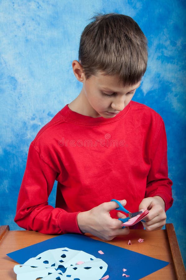 Boy Cuting Pink Paper Snowflake with Scissors Stock Photo - Image of ...
