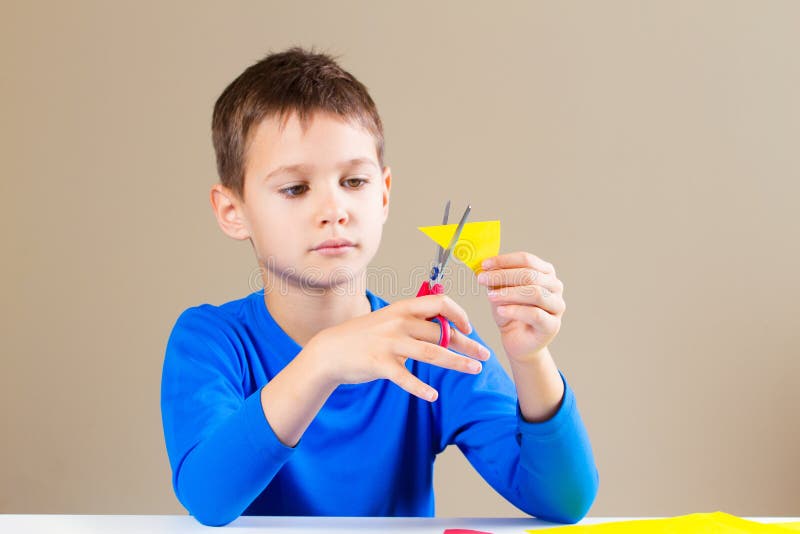 Boy Cutting Colored Paper with Scissors Stock Image - Image of learning ...