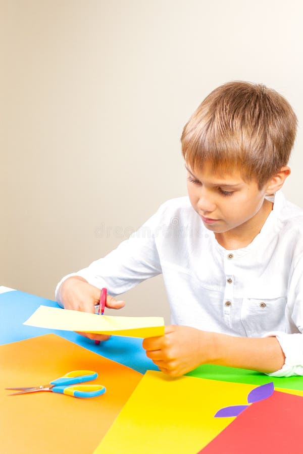 Child Cutting Colored Paper with Scissors at the Table Stock Image ...