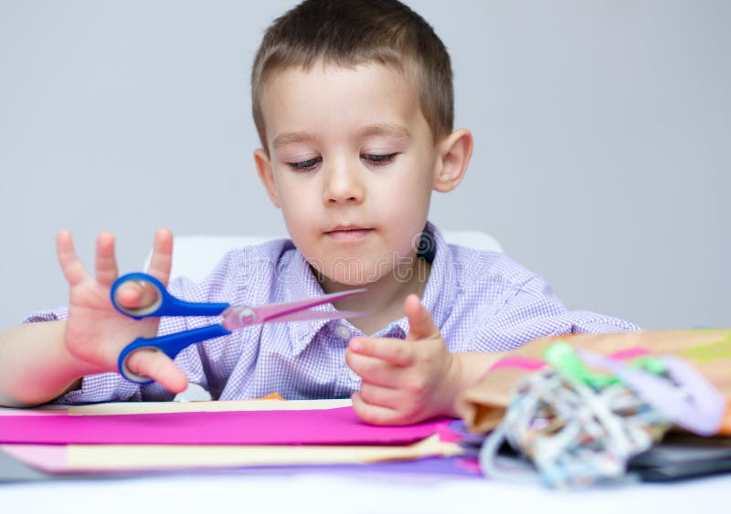 Boy is Cutting Paper Using Scissors Stock Photo - Image of person ...