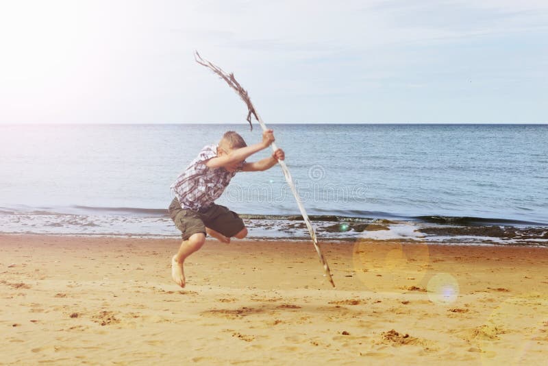 Boy dancing on the beach stock photo. Image of water - 57445864