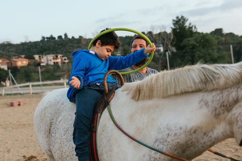 Boy with Disabilities Riding a Horse while Having an Equine Therapy ...