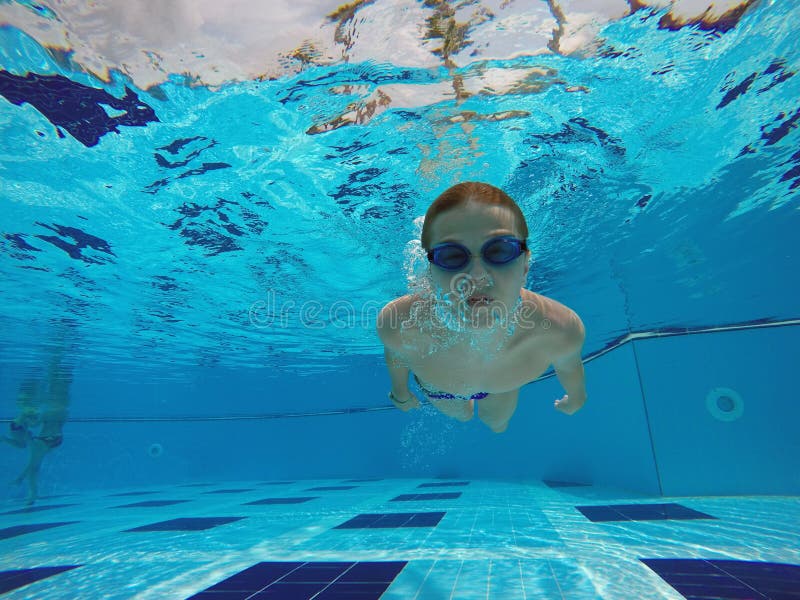 Boy Diving into a Swimming Pool Stock Photo - Image of young, bubbles ...