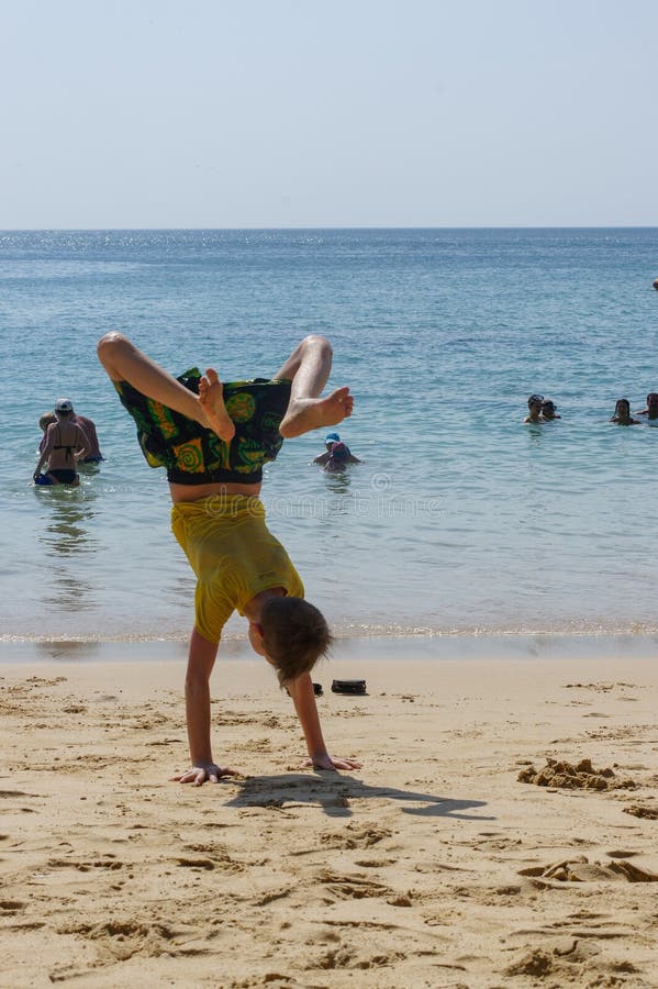 Boy Do Handstand by the Sea on Beach Editorial Stock Image - Image of ...
