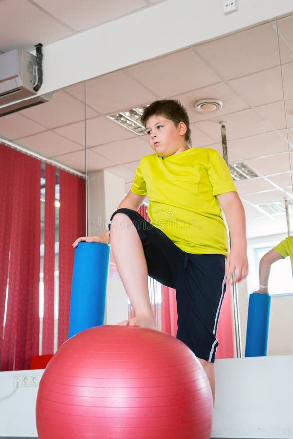Boy Does Exercise with the Ball in Gym Stock Image - Image of playful ...