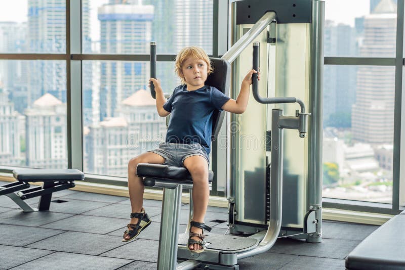 The Boy Does Exercises in a Fitness Room Stock Image - Image of lifting ...