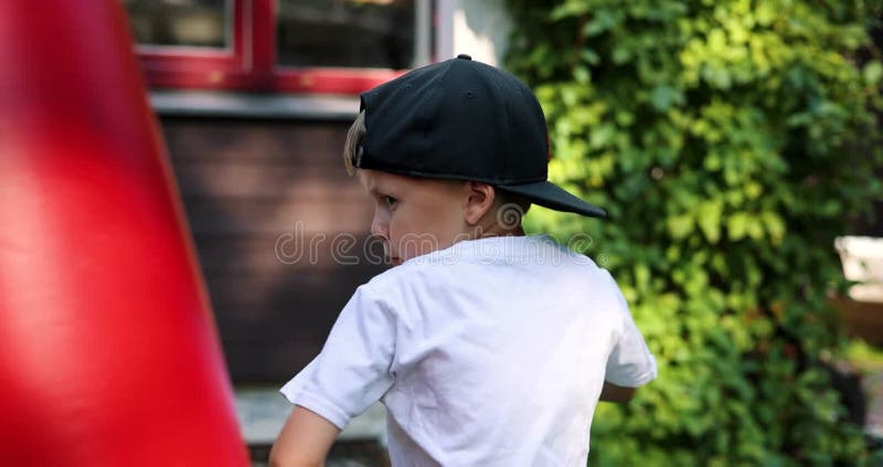 Boy Doing Boxing Workout with Inflatable Punching Bag and Gloves Stock ...
