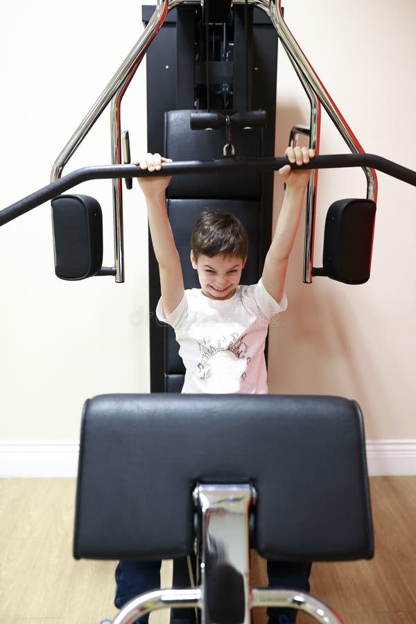 Boy Doing Exercises for Back Load on Simulator Stock Photo - Image of ...