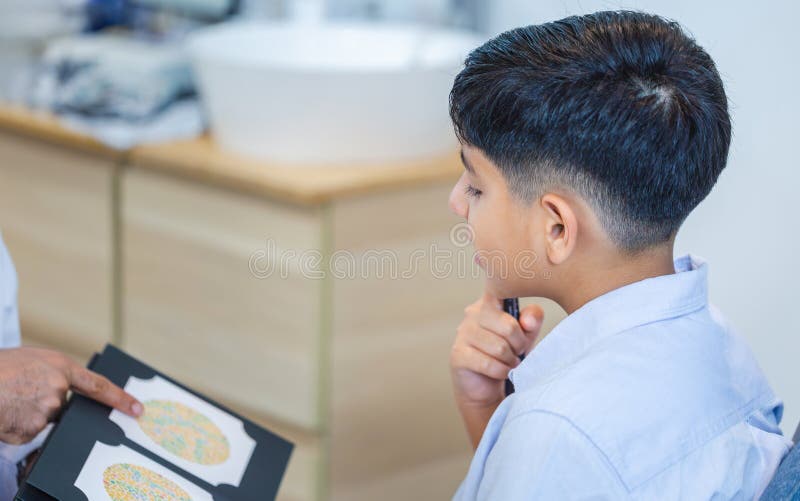 Boy Doing Eye Test Checking Examination with Optometrist in Optics ...