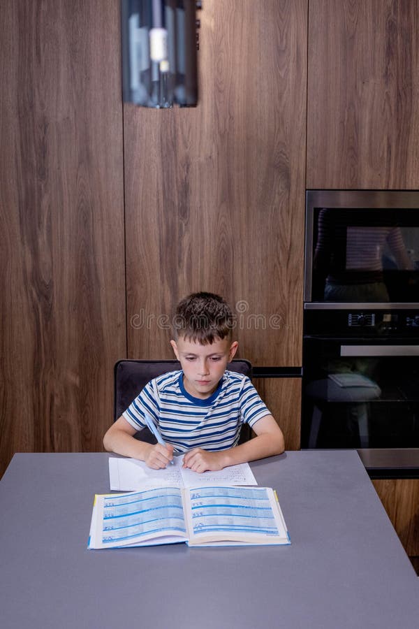 Boy is Doing His Homework in the Kitchen Stock Photo - Image of desk ...