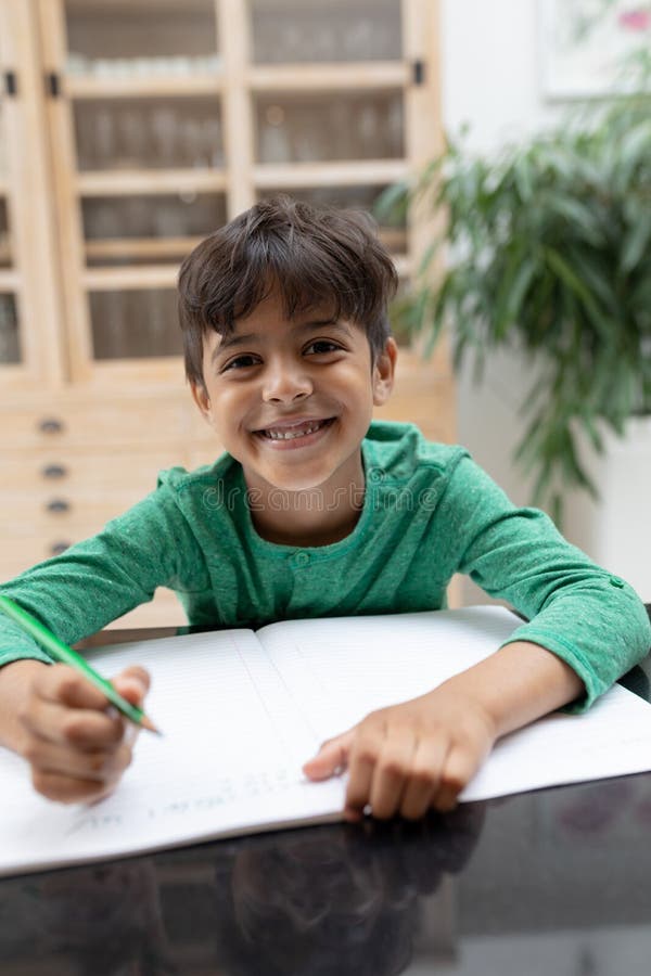 Boy Doing His Homework on a Table at Home Stock Image - Image of ...