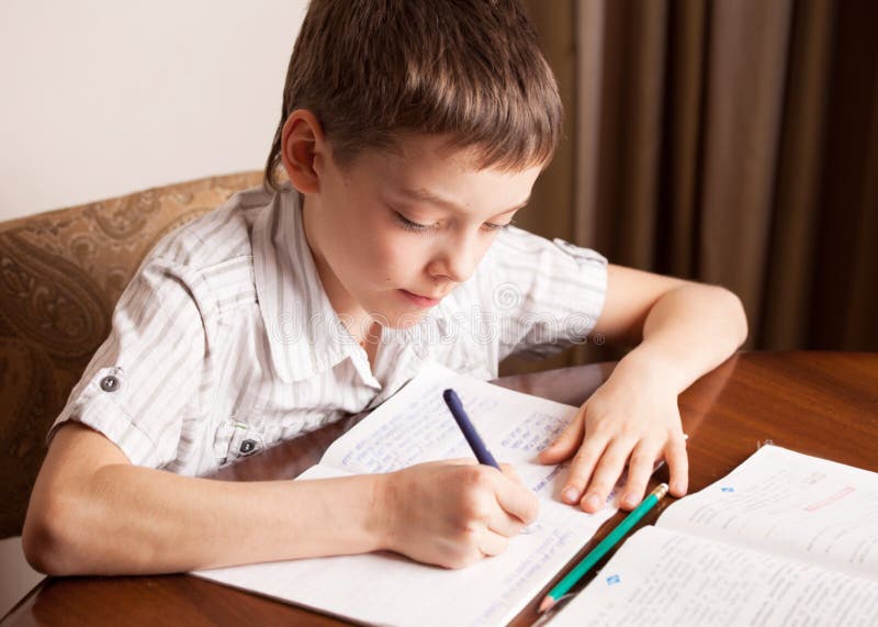 Boy doing homework stock photo. Image of student, teenagers - 153195484