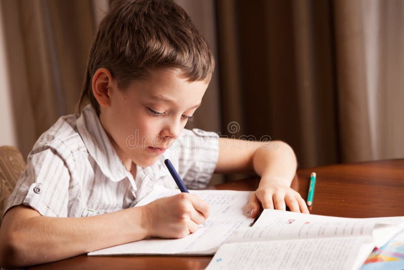 Boy doing homework stock image. Image of home, sitting - 153195527