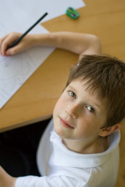 Boy doing homework/drawing stock image. Image of studious - 4828399