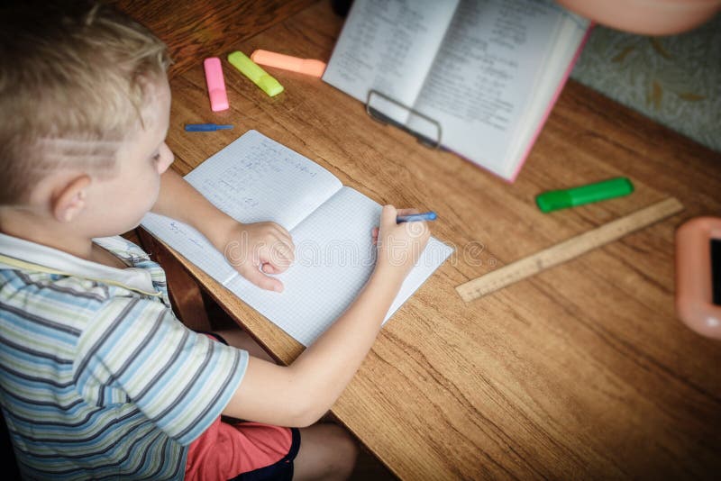 Boy doing homework at home stock photo. Image of childhood - 172037996
