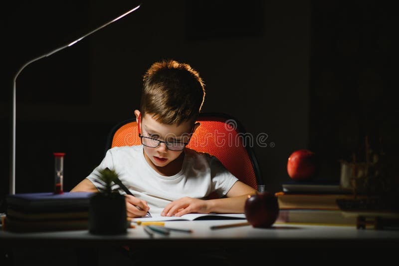 Boy Doing Homework at Home in Evening Stock Photo - Image of school ...