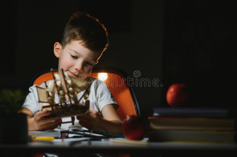 Boy Doing Homework at Home in Evening Stock Photo - Image of dark ...