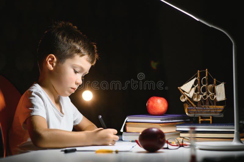 Boy Doing Homework at Home in Evening Stock Image - Image of studying ...