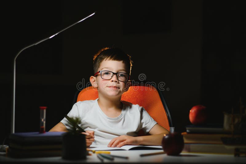 Boy Doing Homework at Home in Evening Stock Photo - Image of desk ...