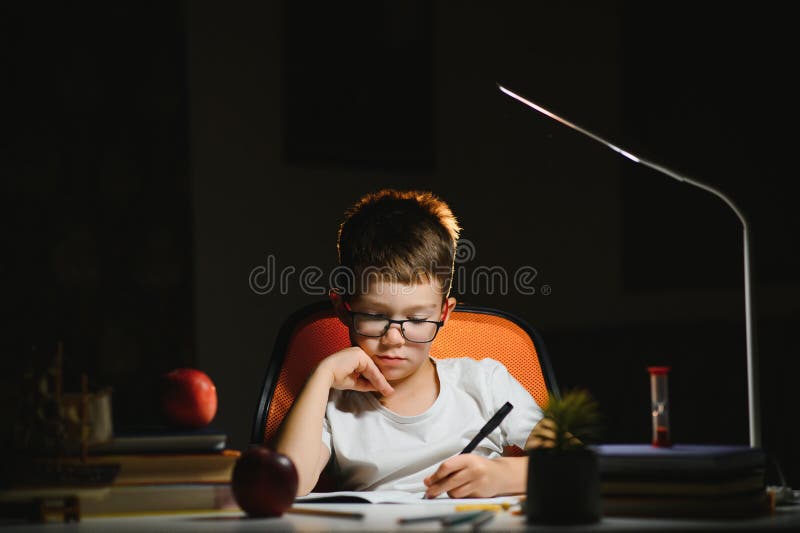 Boy Doing Homework at Home in Evening Stock Photo - Image of youth ...