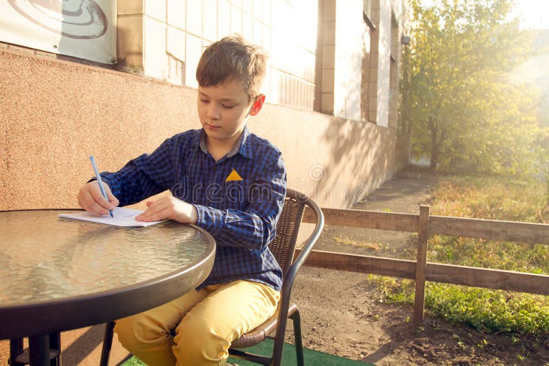 Boy is Doing Homework Outdoors Stock Image - Image of letter, cute ...