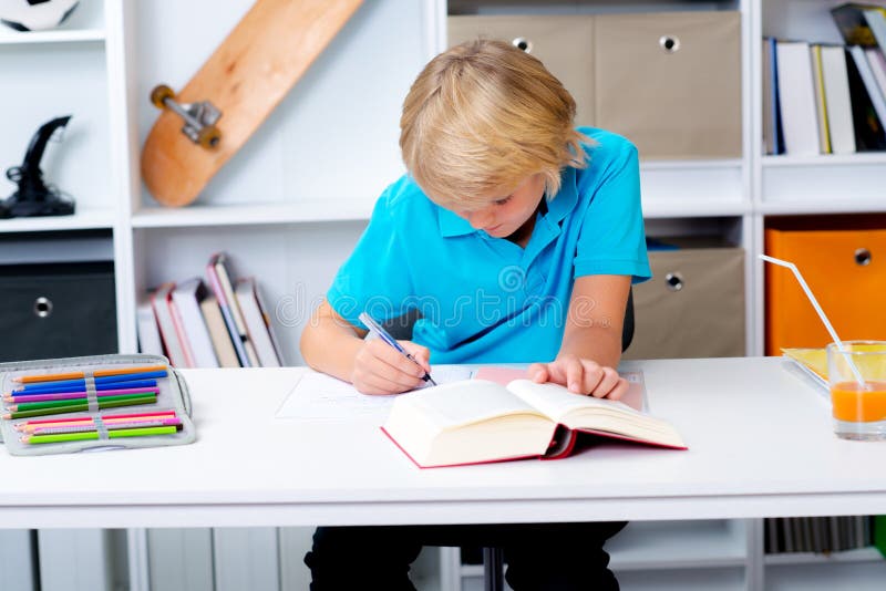 Boy Doing Homework and Reading a Book Stock Photo - Image of reading ...