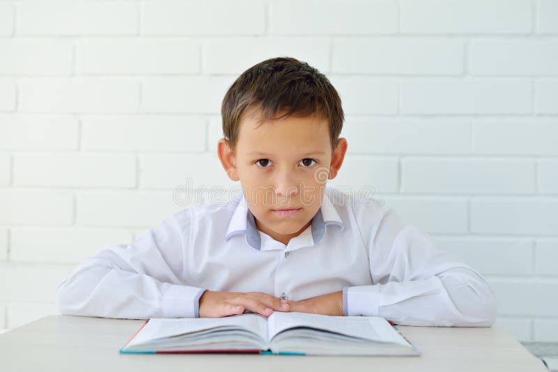 Boy doing homework stock image. Image of reading, shirt - 177723799