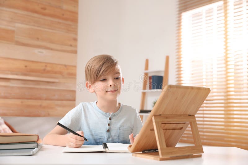 Boy Doing Homework with Tablet at Table Stock Photo - Image of computer ...