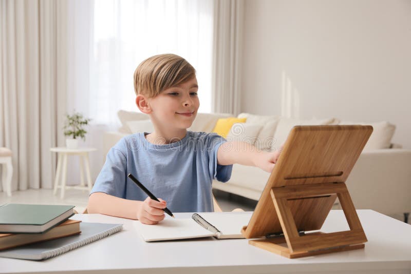 Boy Doing Homework with Tablet at Table Stock Image - Image of child ...