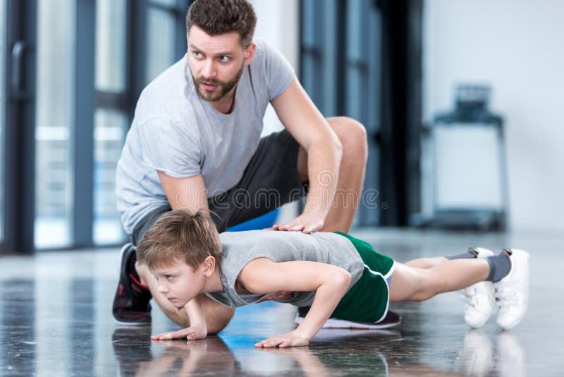 Boy Doing Push Ups with Coach Stock Image - Image of together, daylight ...