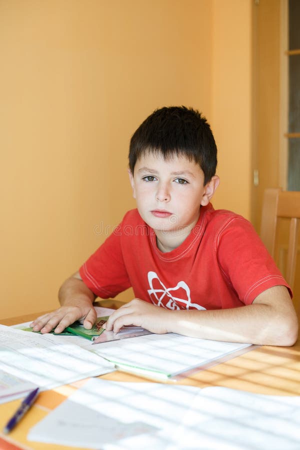 Boy Doing Homework From School In Workbook Picture. Image: 23234986