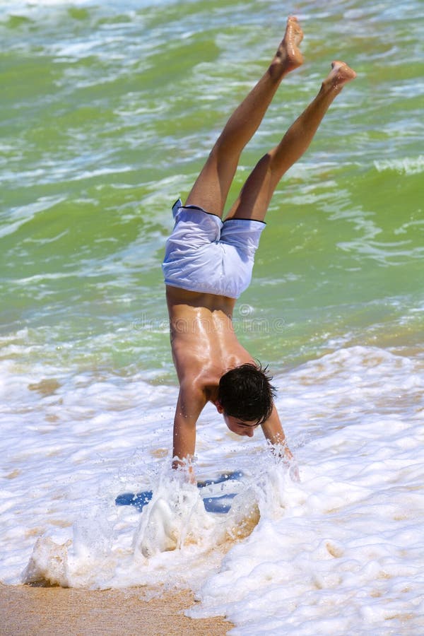 Boy Doing Somersaults on Seacoast Stock Image - Image of enjoying ...