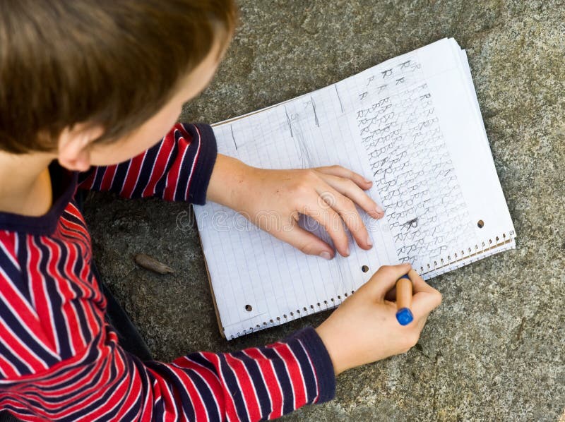 Boy doing writing homework stock image. Image of education - 7286905