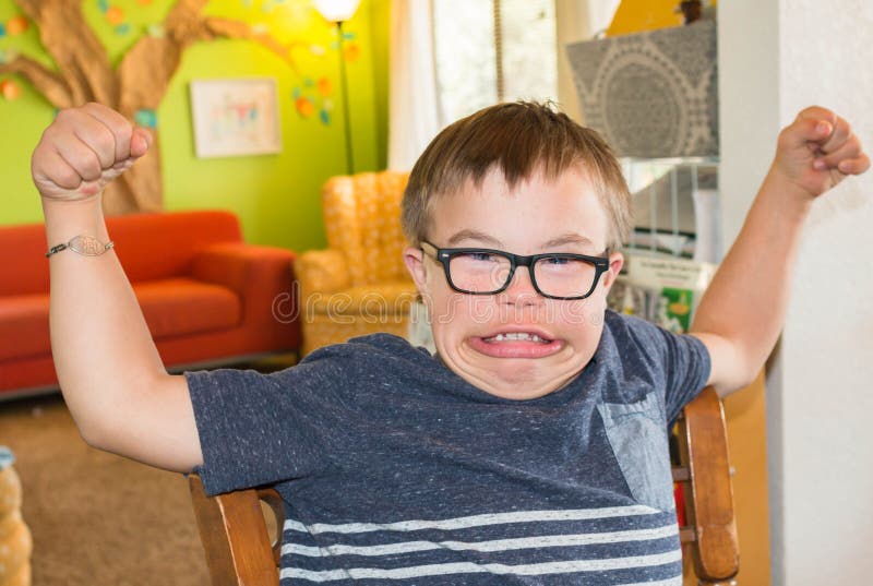 Boy with Downs Syndrome Flexing His Muscles Stock Photo - Image of ...